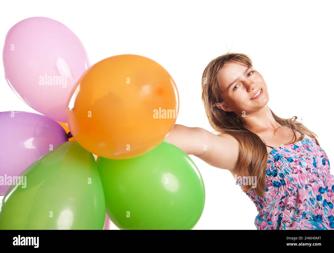 Cute teenage girl holding balloons on white Stock Photo - Alamy