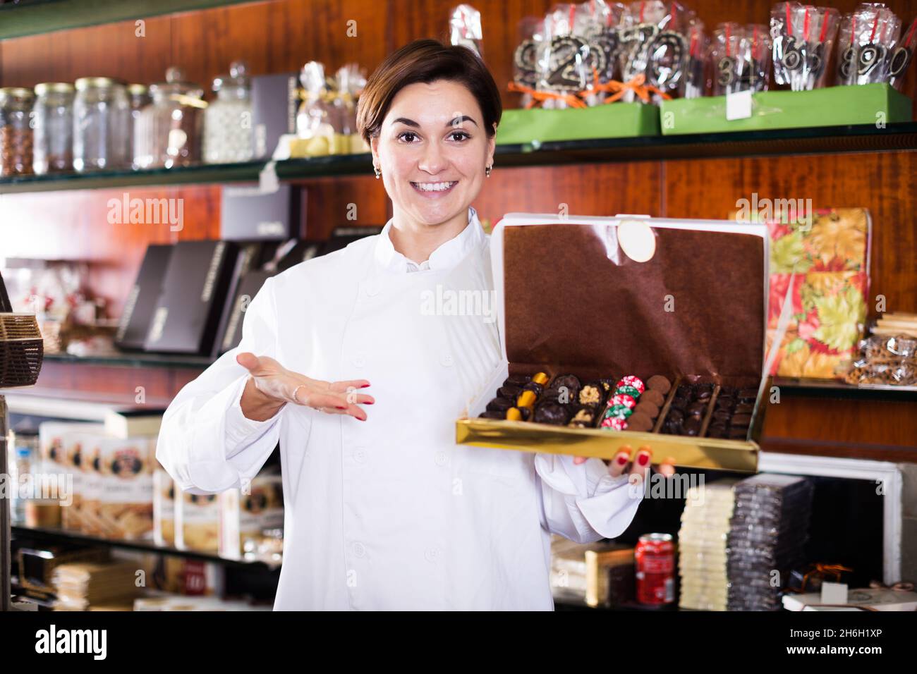 Shop assistant demonstrating box of chocolates Stock Photo - Alamy