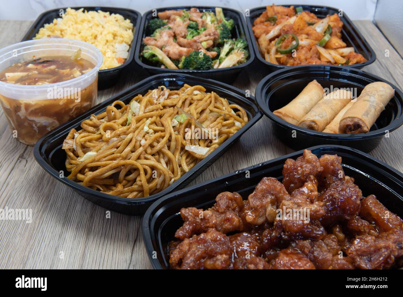 Chinese food feast is on the table buffet style with seasoned potatoes ...