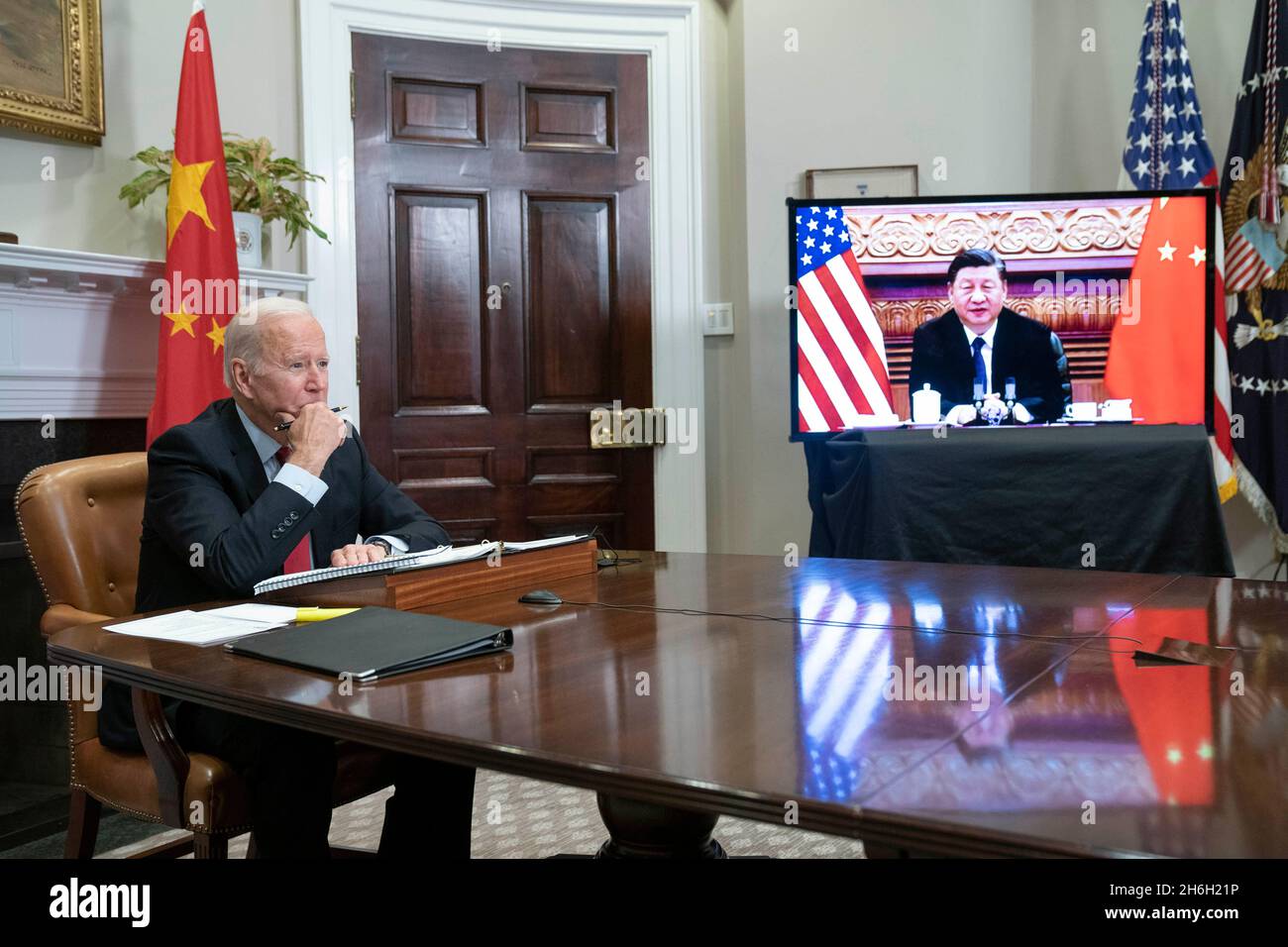 President Joe Biden listens during a virtual summit with Chinese ...