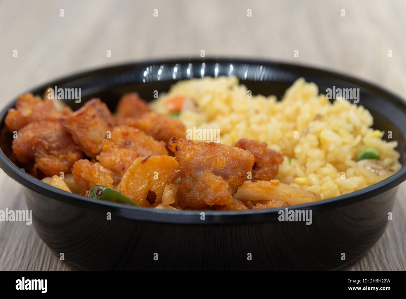 Tradiional Chinese fast food meal with fried rice and seasoned chicken ...