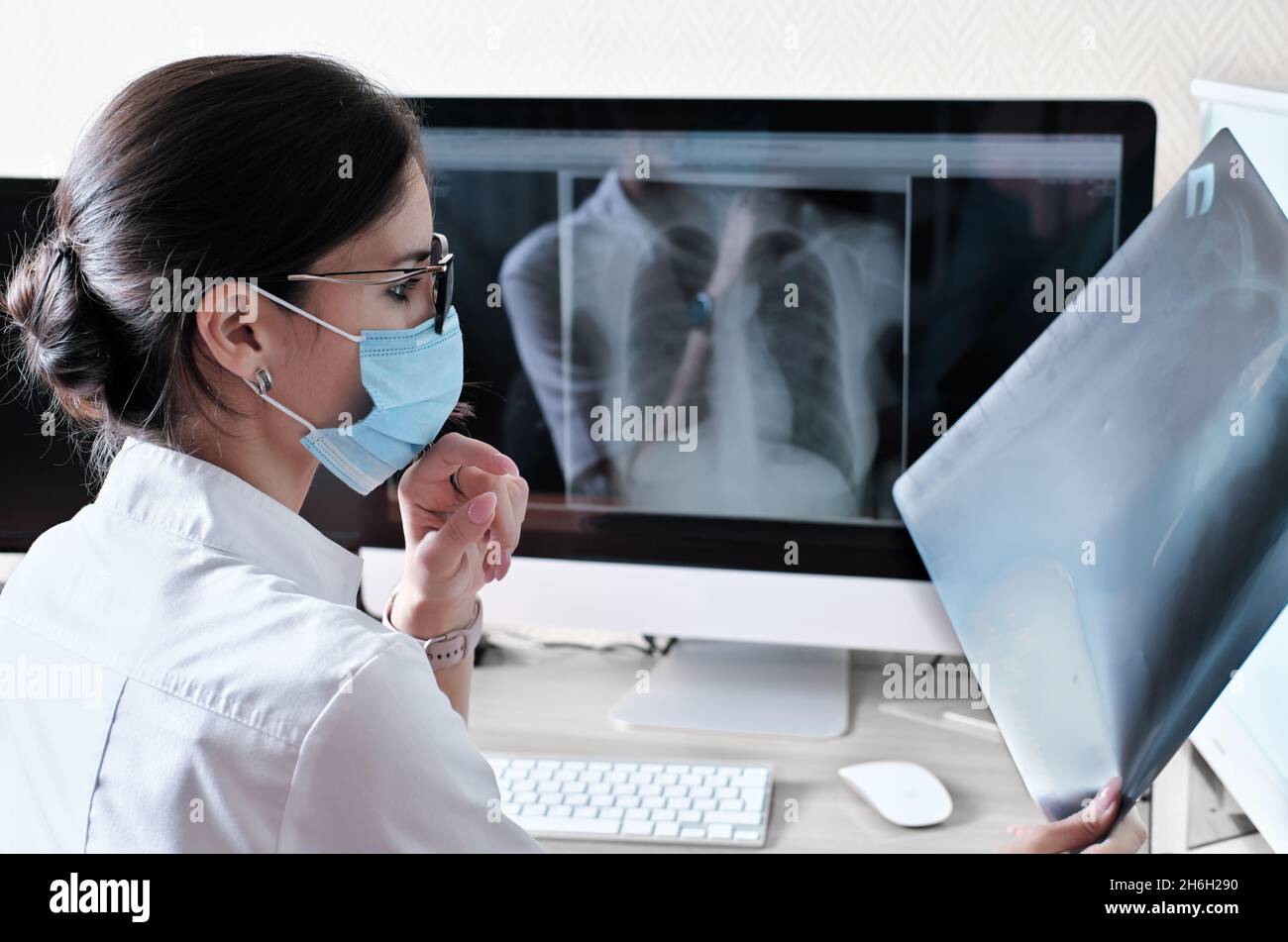 Asian woman doctor radiologist examining film x-ray image. Analyze a ...