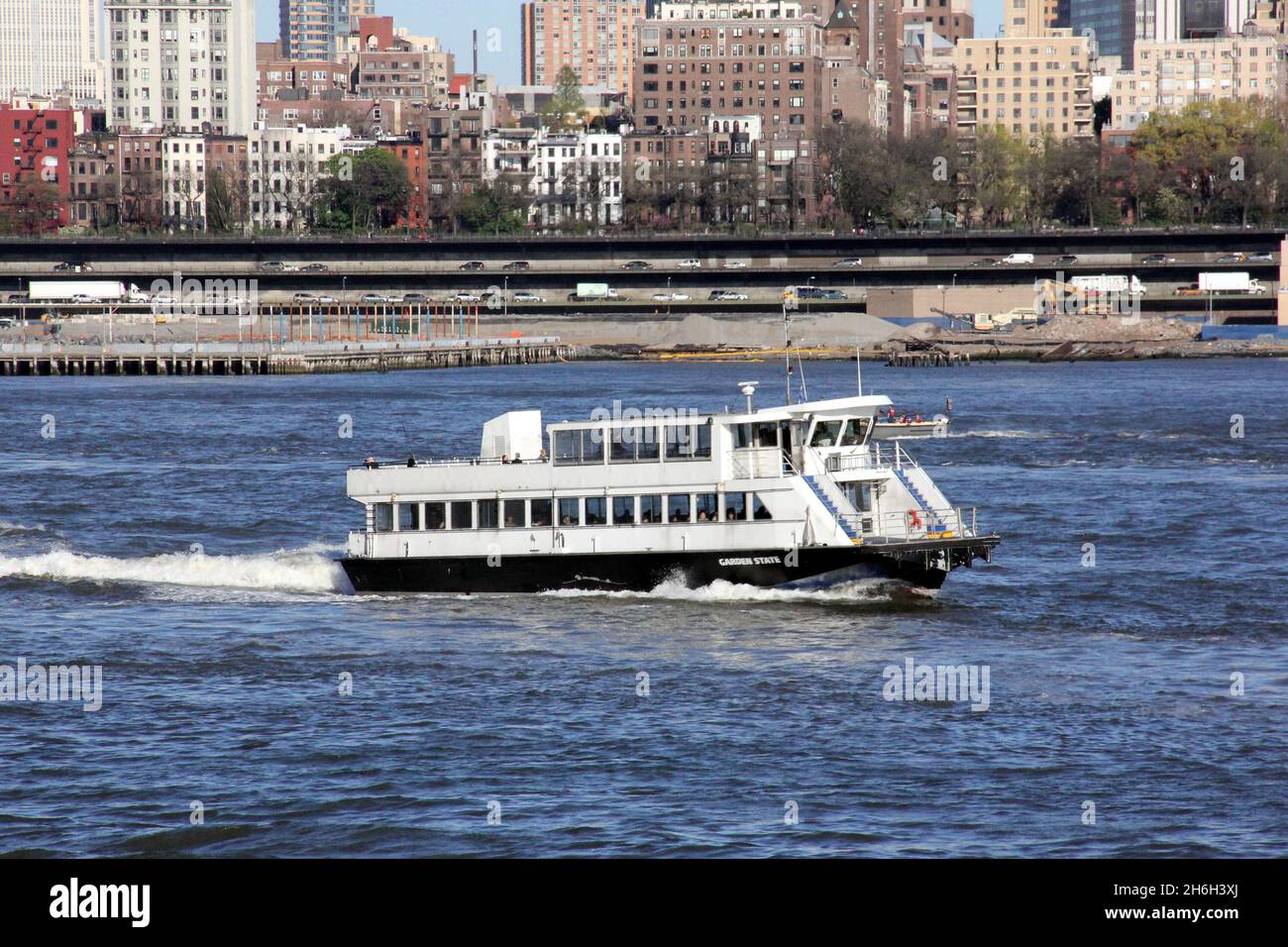Commuter speedboat GARDEN STATE underway against background of Brooklyn ...