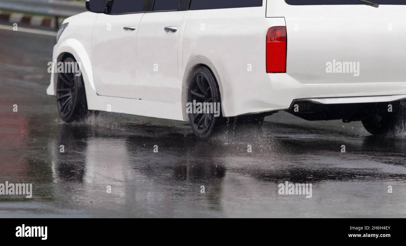 Heavy rain and puddles on the road cause skidding or sliding of a cars ...