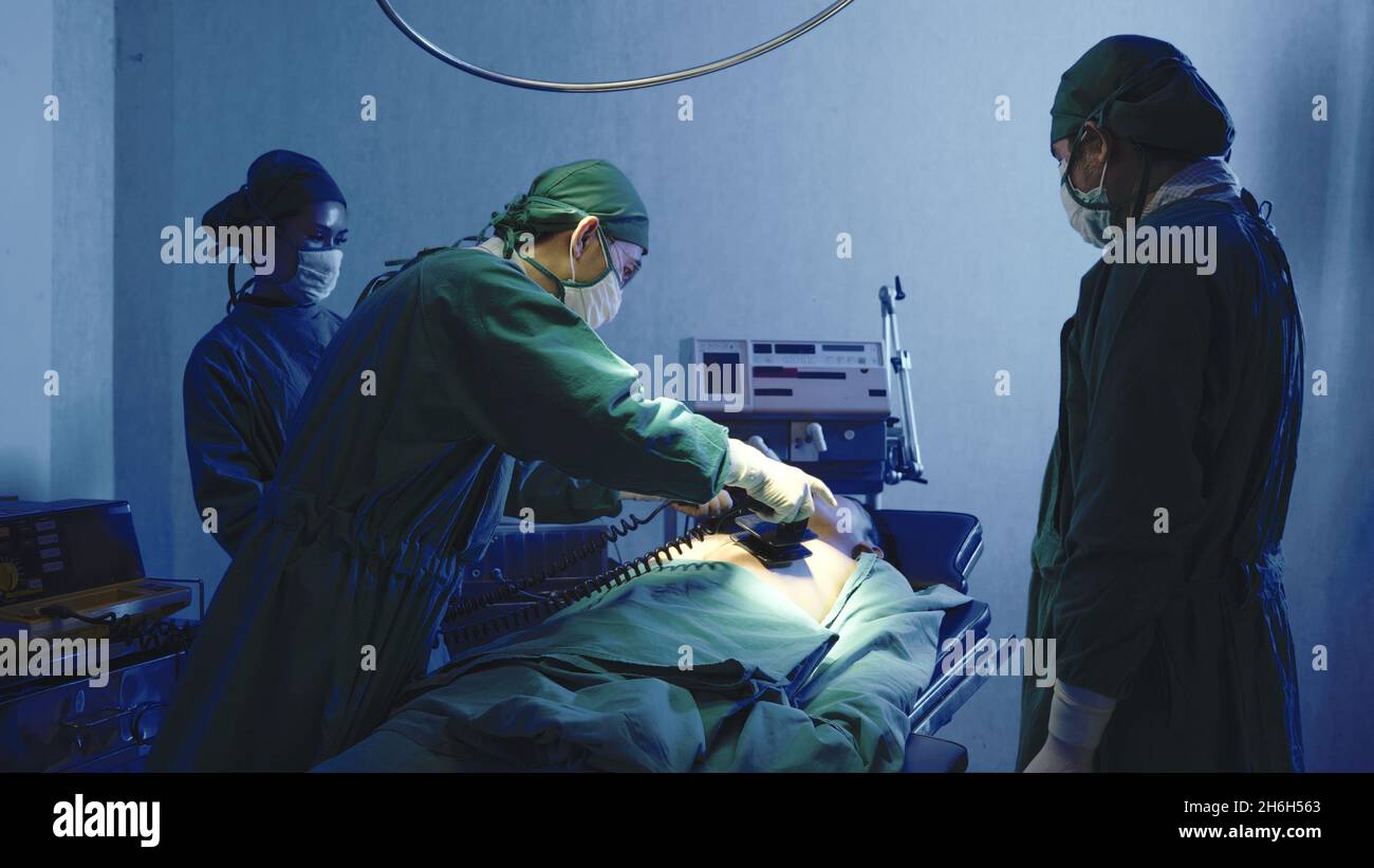 Defibrillation cardiac dysrhythmia, Surgical doctor team performing ...