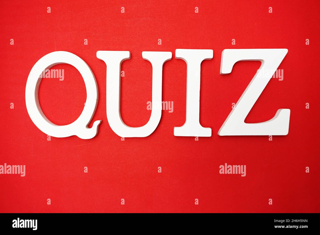 Top view Quiz letters alphabet letters on red Stock Photo - Alamy