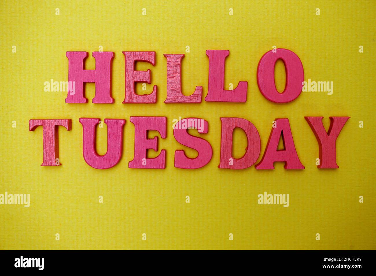 Hello Tuesday alphabet letters on yellow background Stock Photo - Alamy