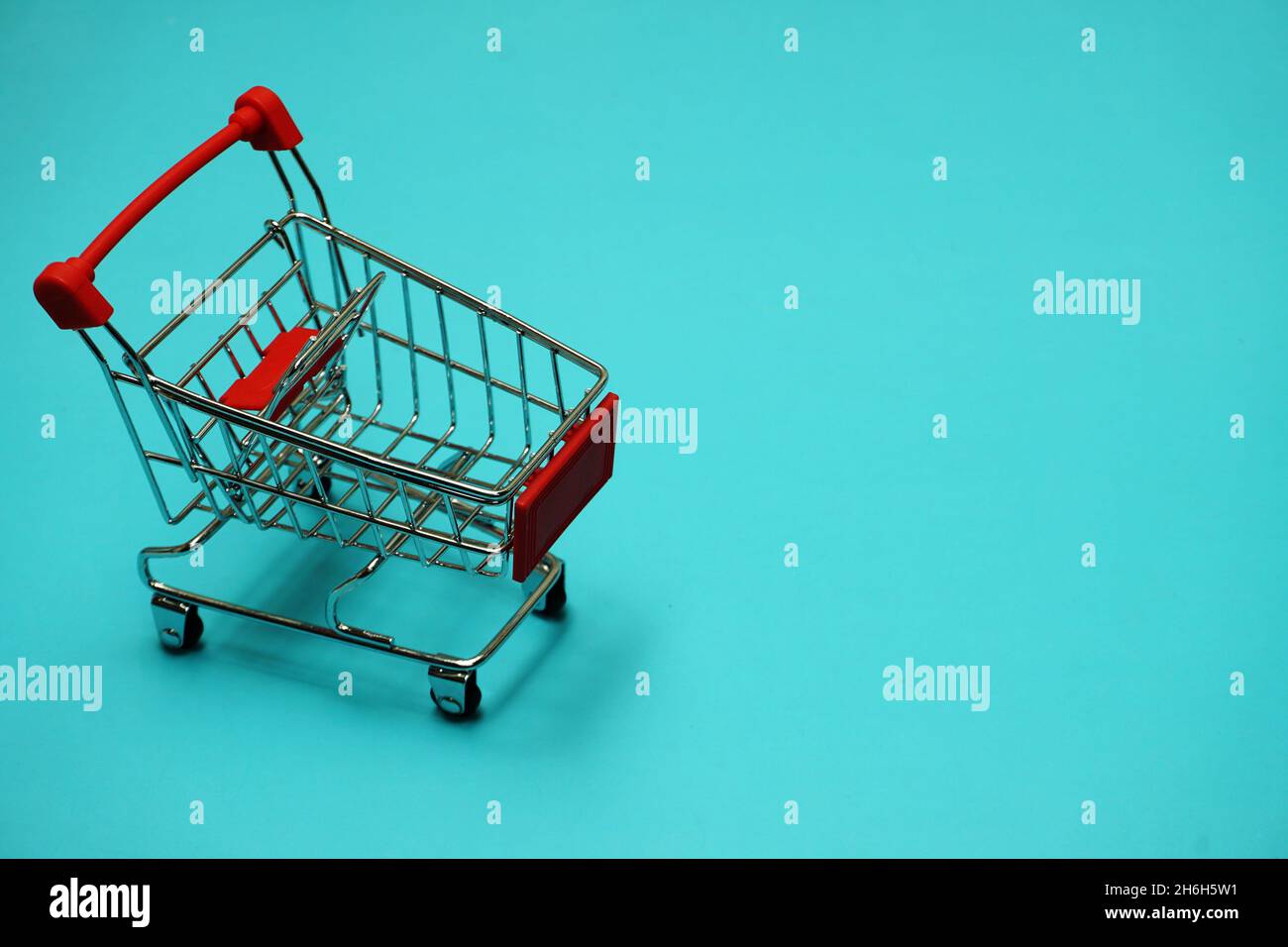 Mini trolley cart on blue background Stock Photo - Alamy