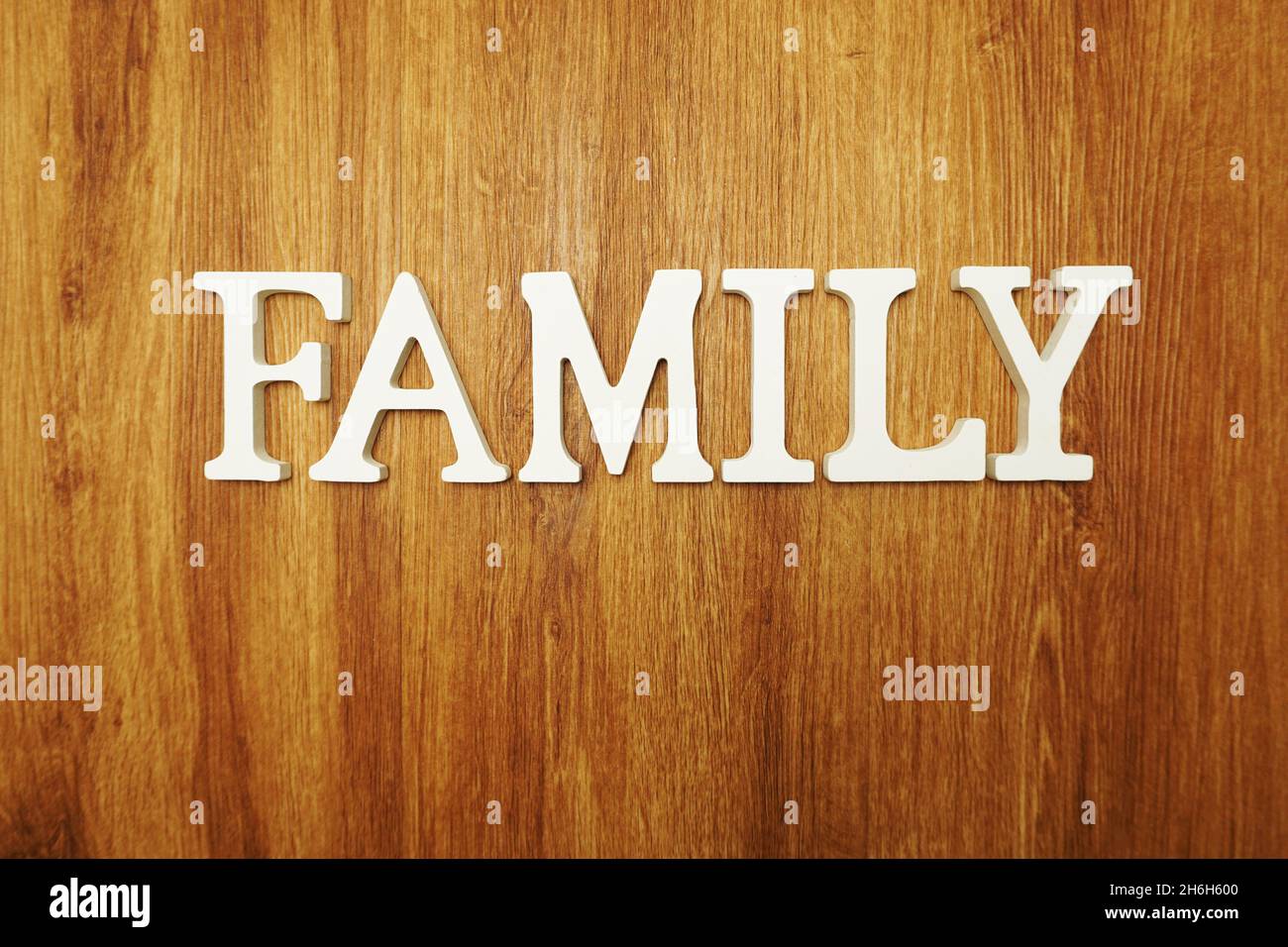 Family word alphabet letters on wooden background Stock Photo - Alamy