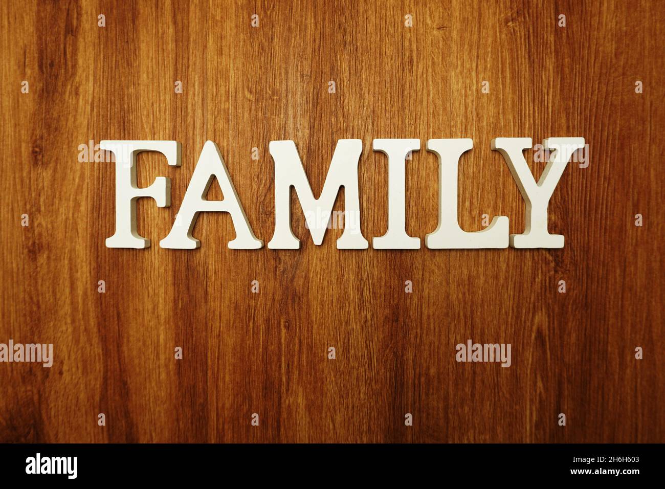 Family word alphabet letters on wooden background Stock Photo - Alamy