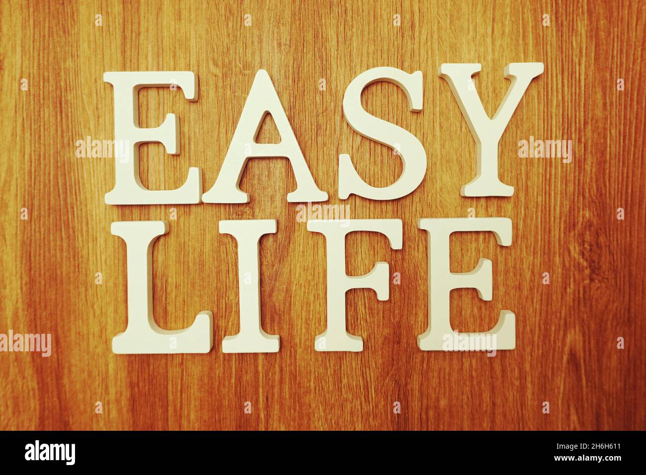 Easy Life word alphabet letters on wooden background Stock Photo - Alamy