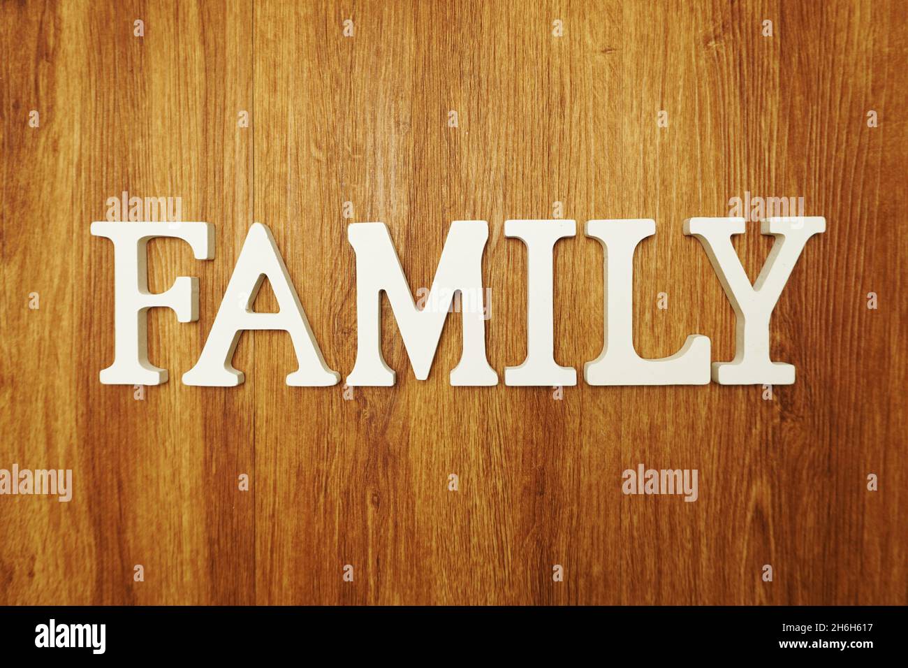 Family word alphabet letters on wooden background Stock Photo - Alamy