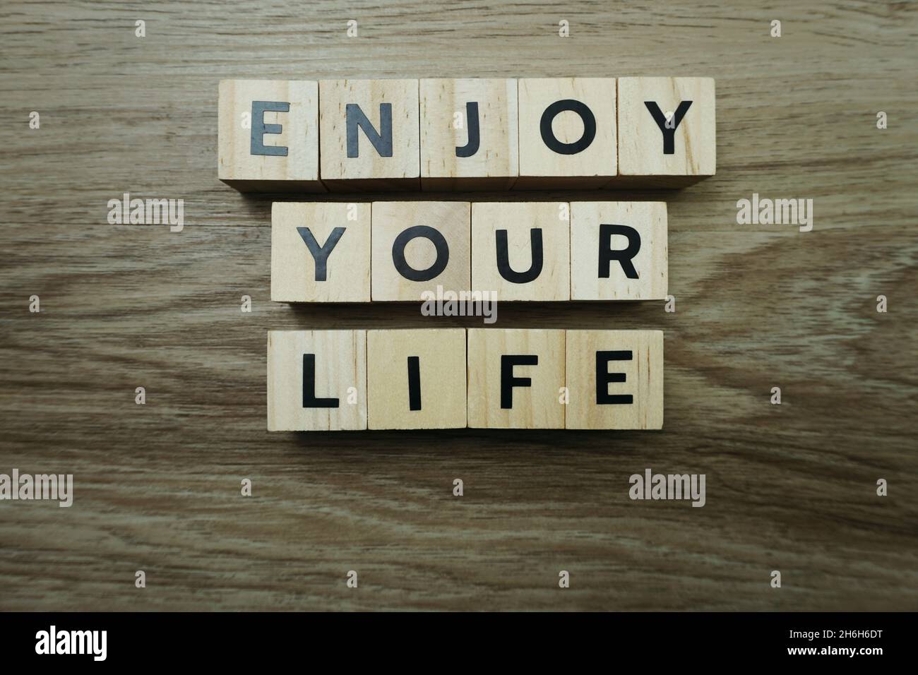 Enjoy Your Life alphabet letter with space copy on wooden background ...