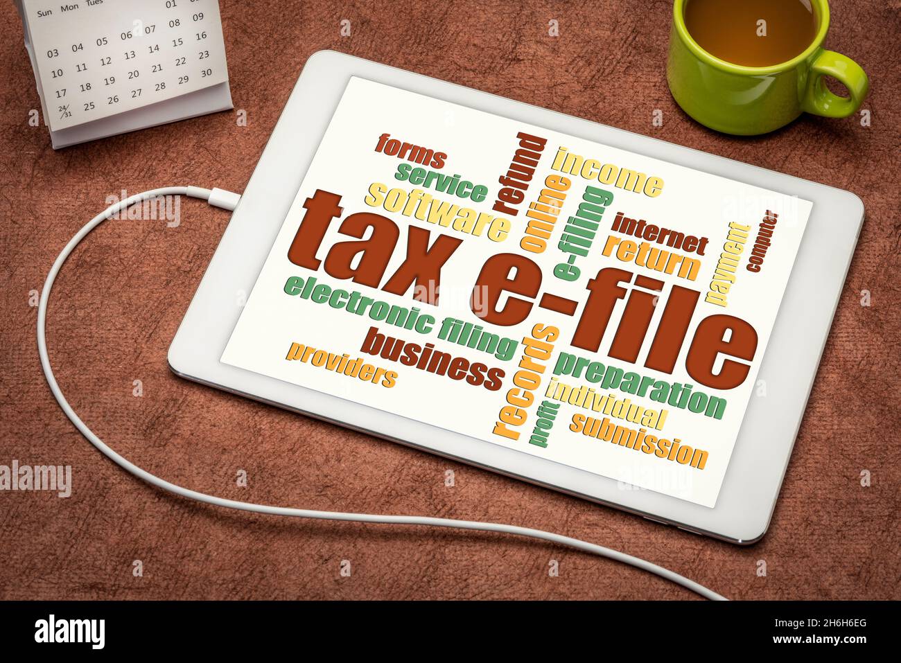 tax electronic filing concept - word cloud on a digital tablet with a ...