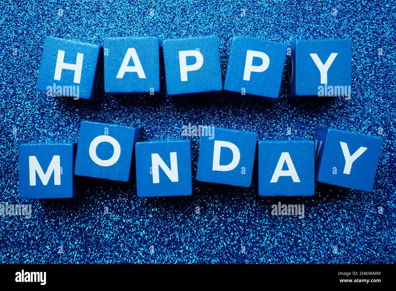 Happy Monday alphabet letter on blue glitter background Stock Photo - Alamy