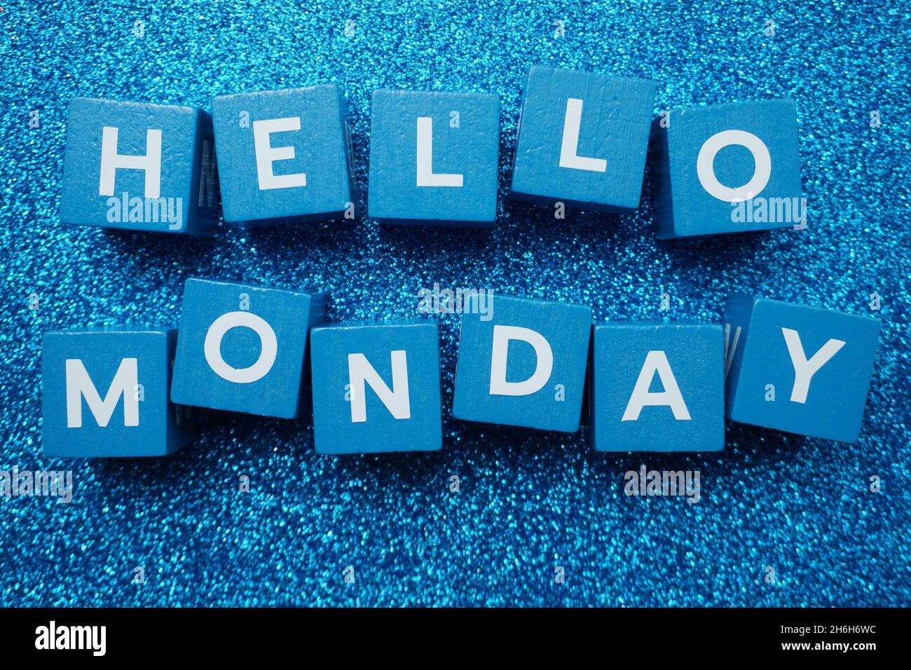 Hello Monday alphabet letter on blue glitter background Stock Photo - Alamy