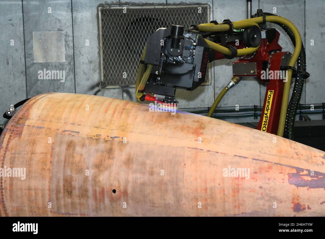 A radome repair robot sands the surface of an F-15 aircraft radome at ...