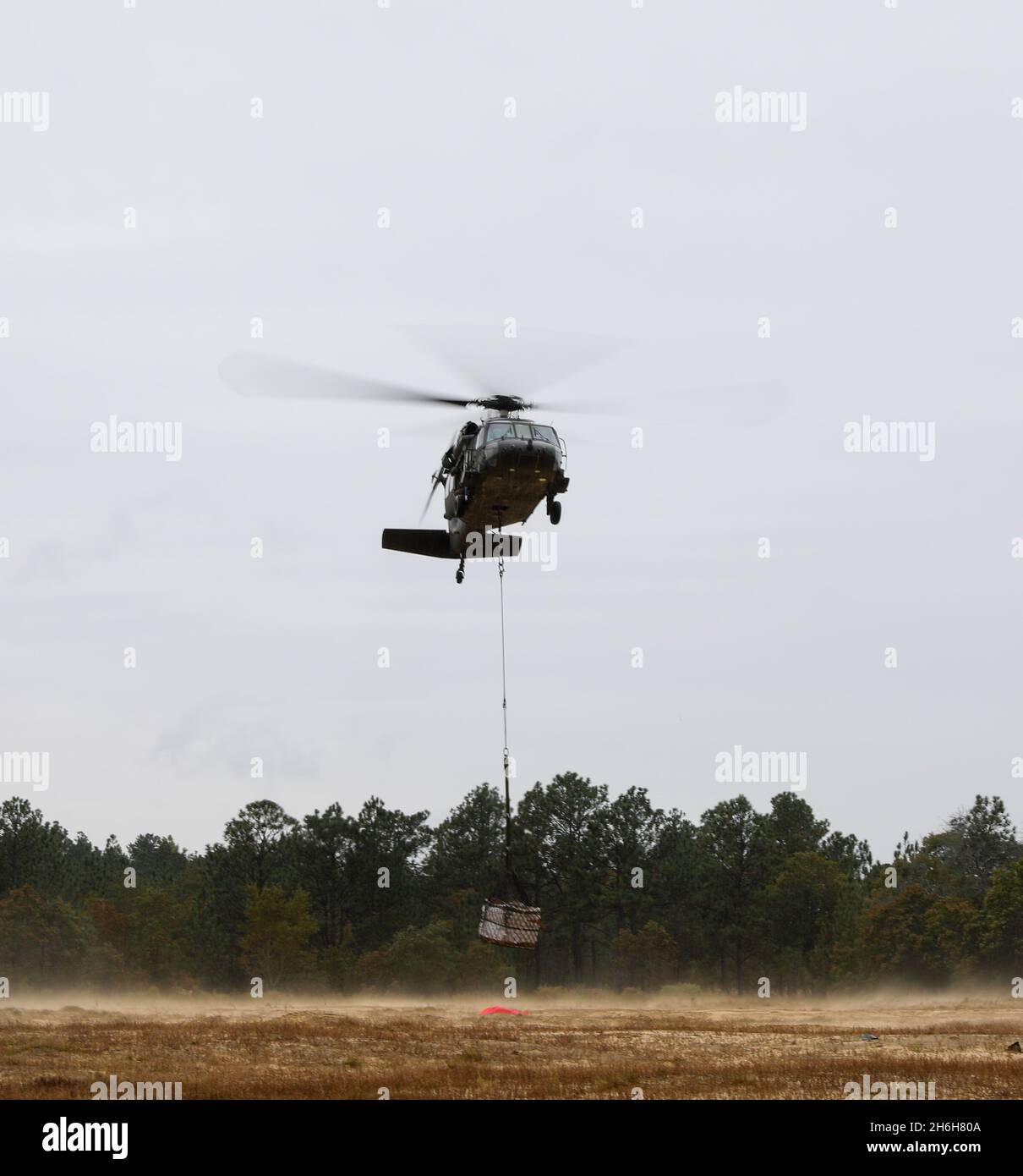 An Apache helicopter completes a sling load operation. The helicopter ...