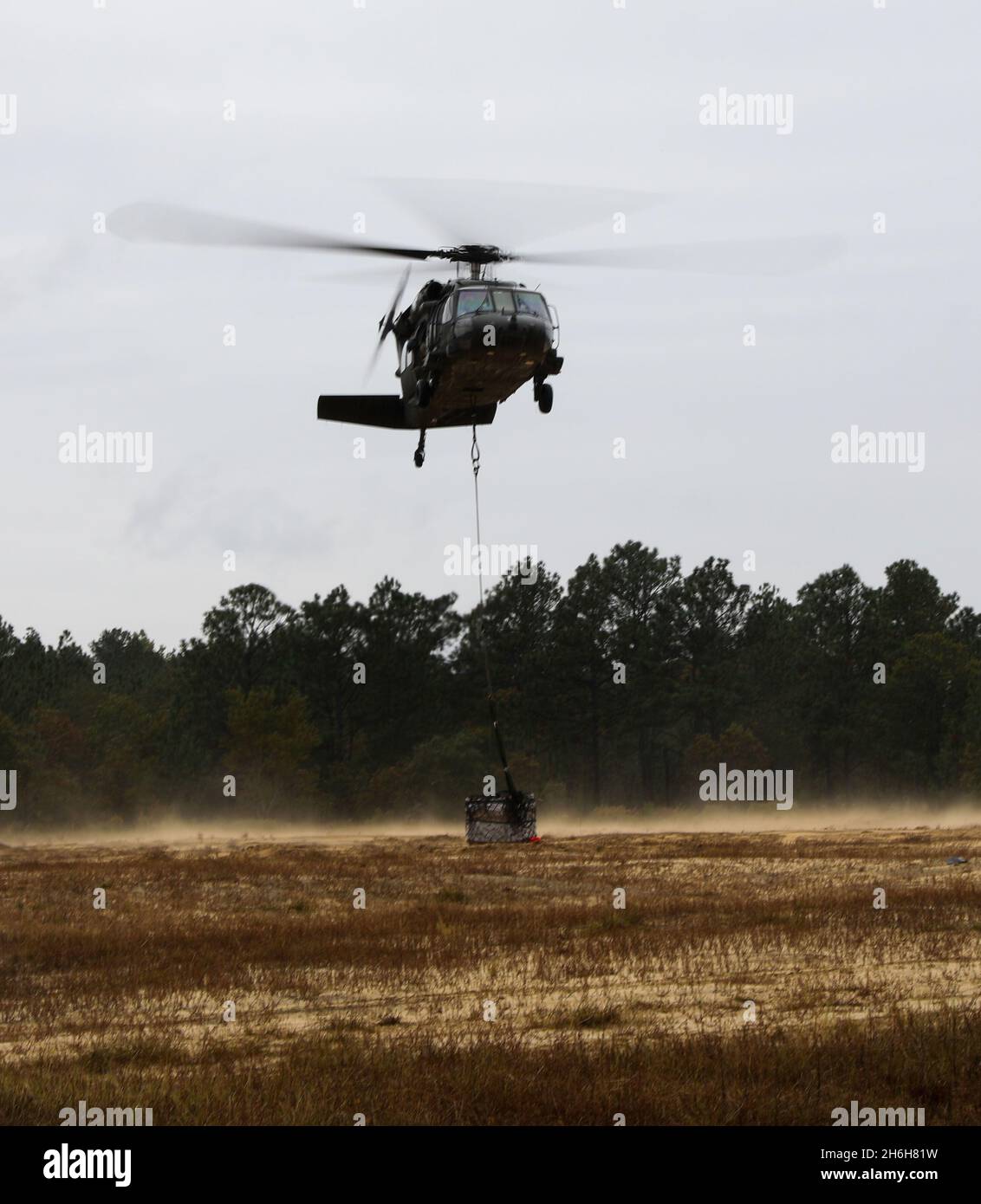 An Apache helicopter completes a sling load operation. The helicopter ...