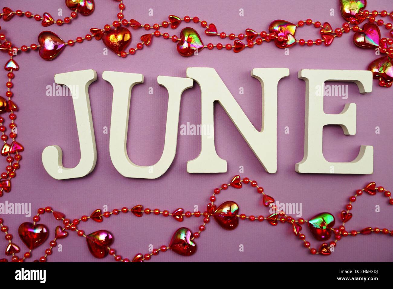 June alphabet letter with space copy on purple background Stock Photo ...