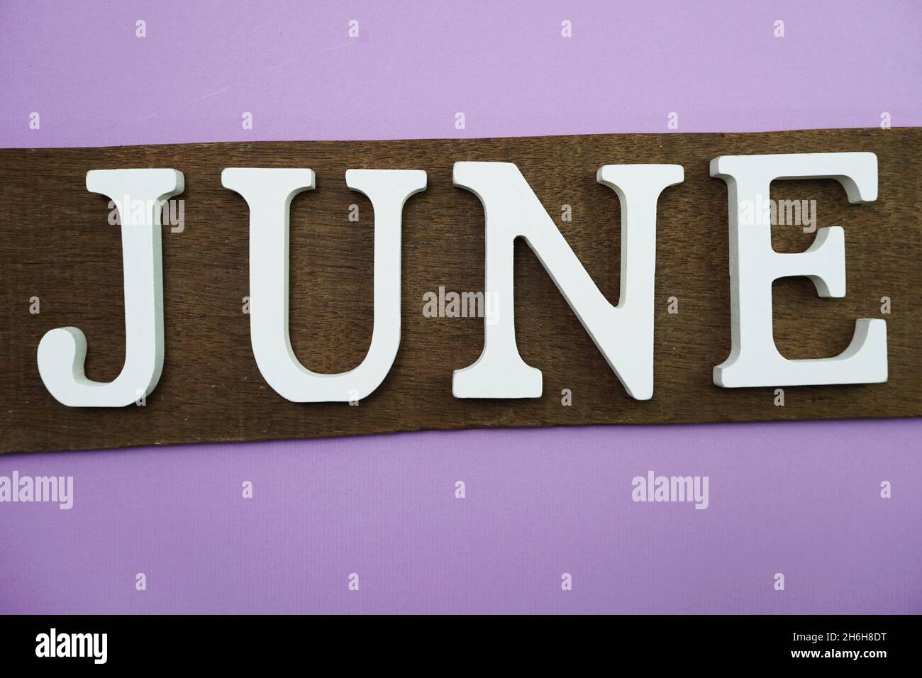 June alphabet letter with space copy on purple background Stock Photo ...
