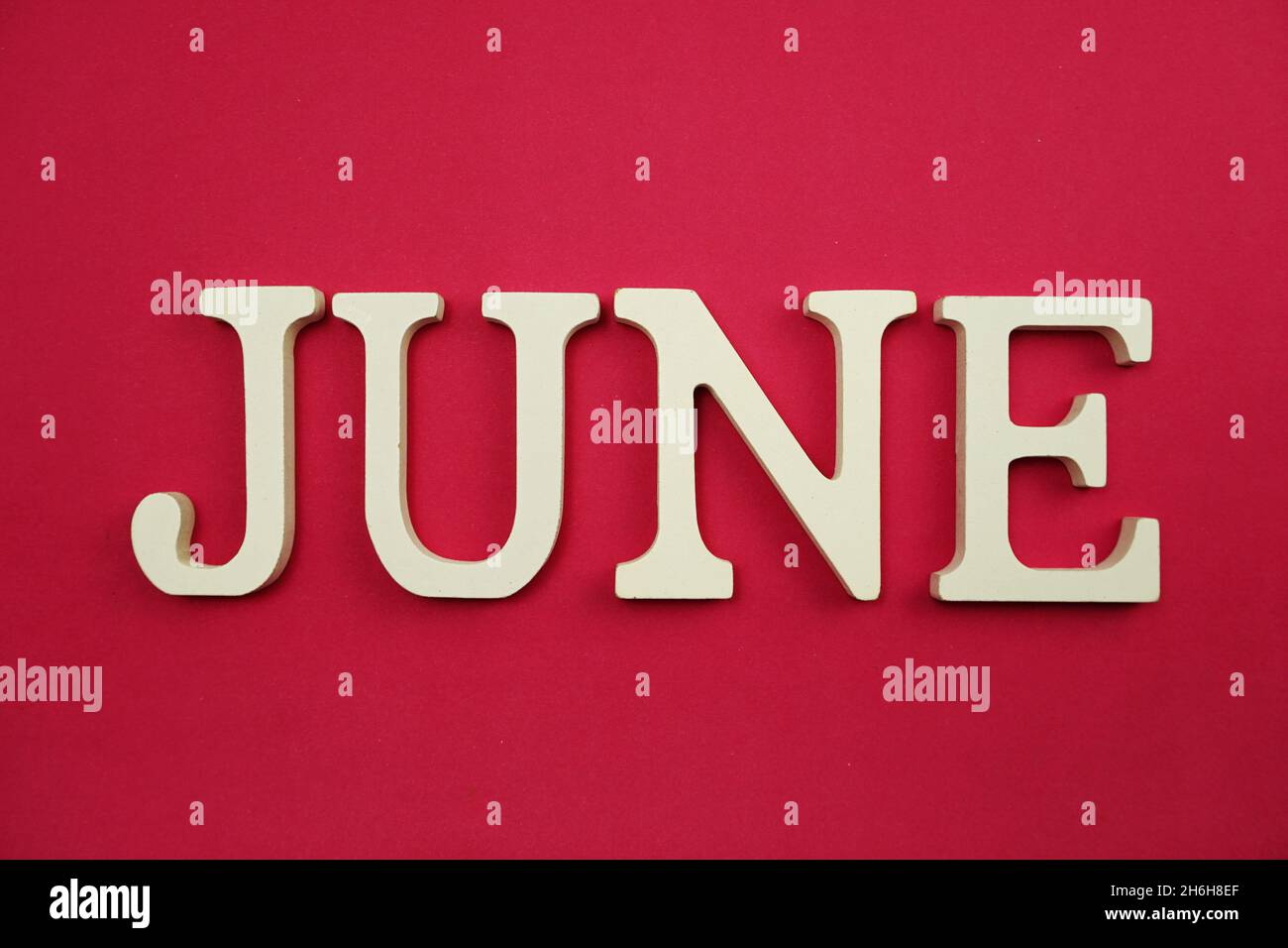 June alphabet letter with space copy on pink background Stock Photo - Alamy