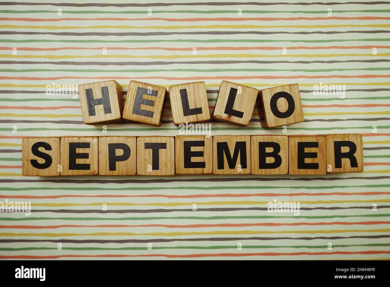 Hello September alphabet letters with space copy on colorful Stripes ...