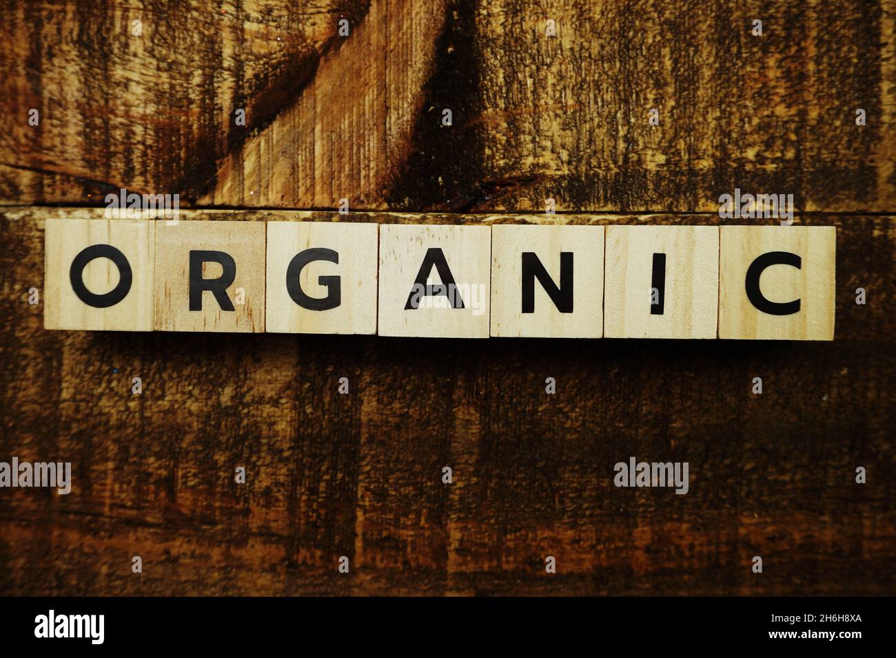 Organic alphabet letters on wooden background Stock Photo - Alamy