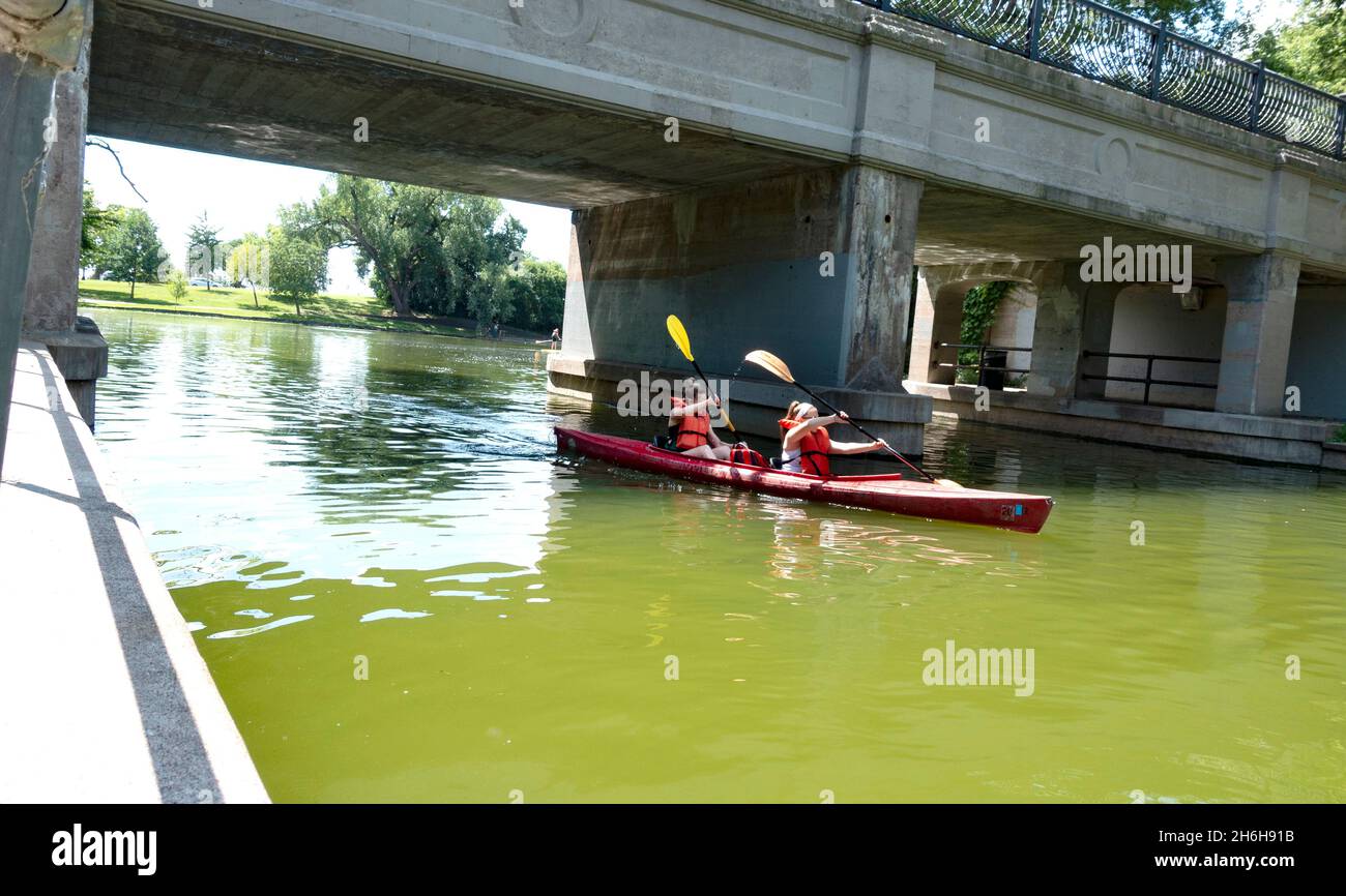 Two person kayak paddling on the waterway between Lake Bde Maka Ska and ...