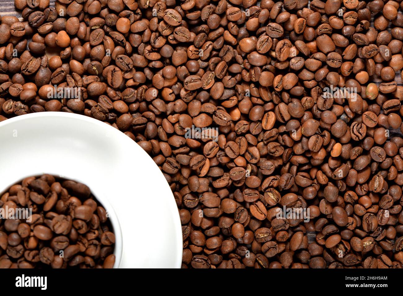 White coffee mug filled with fragrant coffee beans Stock Photo - Alamy
