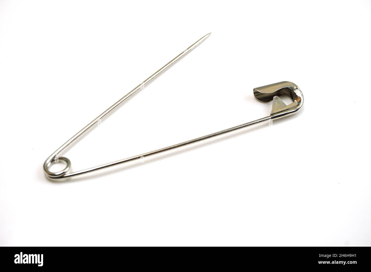 metal safety pins isolated on white background Stock Photo - Alamy