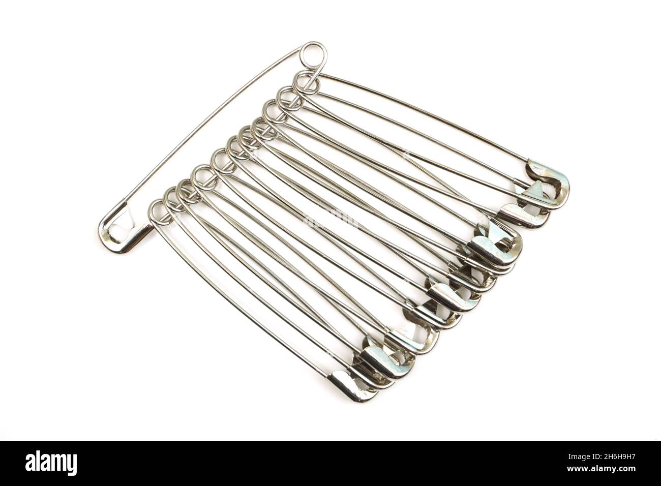 metal safety pins isolated on white background Stock Photo - Alamy