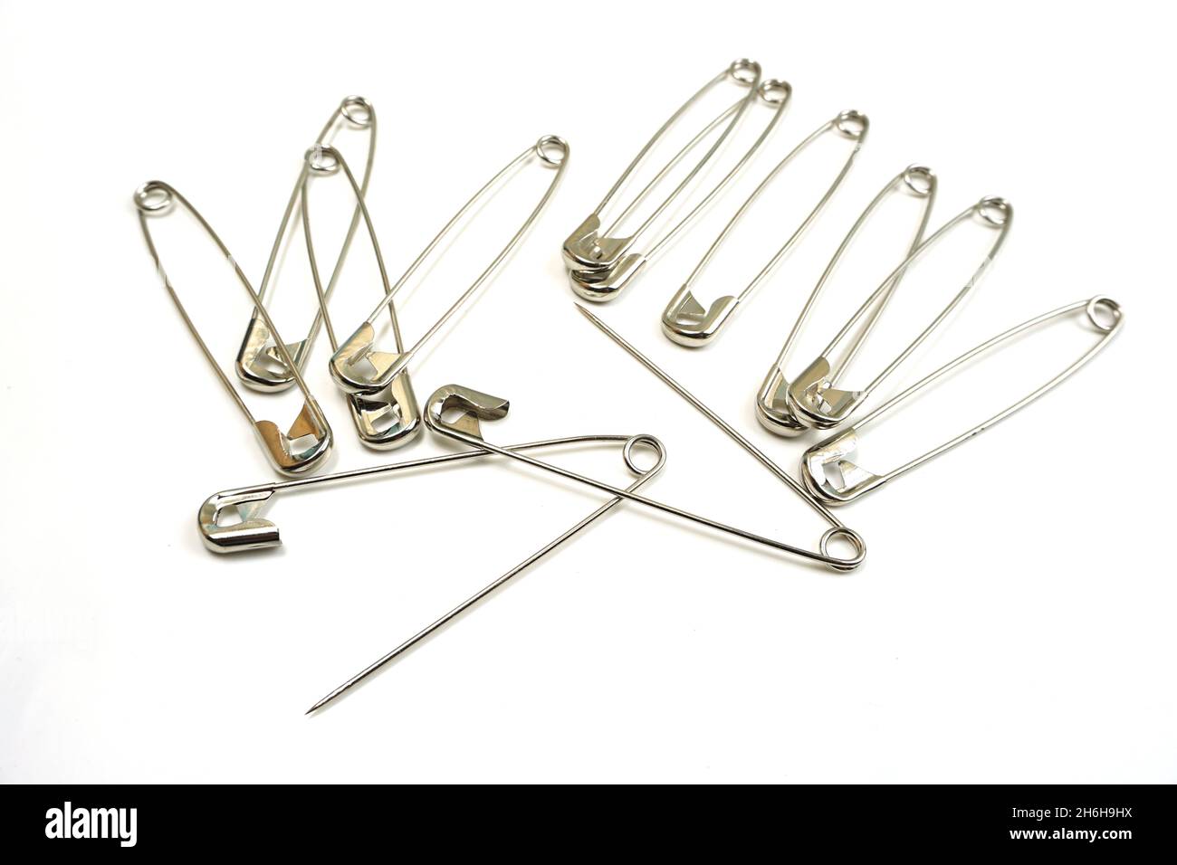 metal safety pins isolated on white background Stock Photo - Alamy