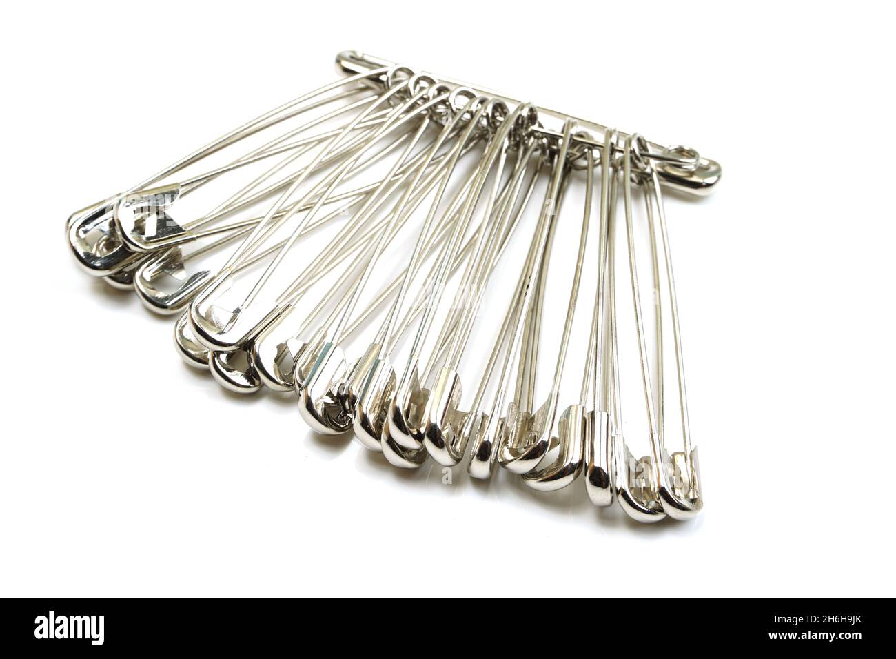 metal safety pins isolated on white background Stock Photo - Alamy