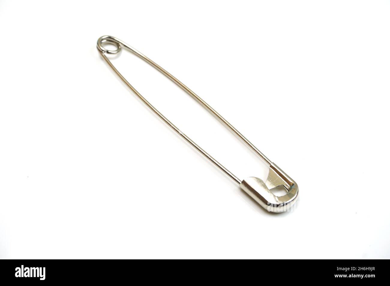 metal safety pins isolated on white background Stock Photo - Alamy