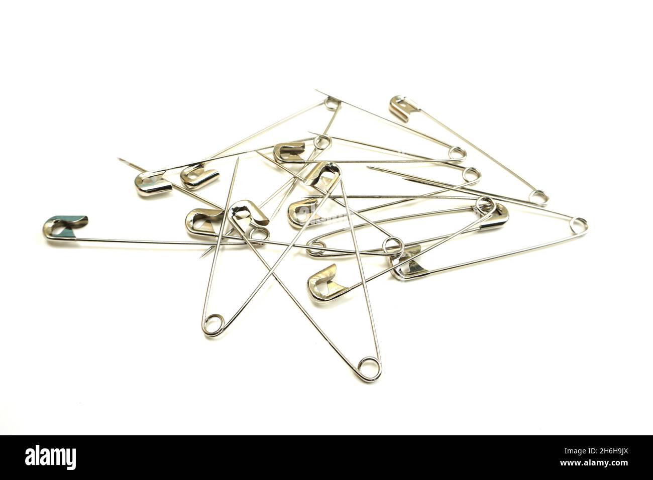 metal safety pins isolated on white background Stock Photo - Alamy