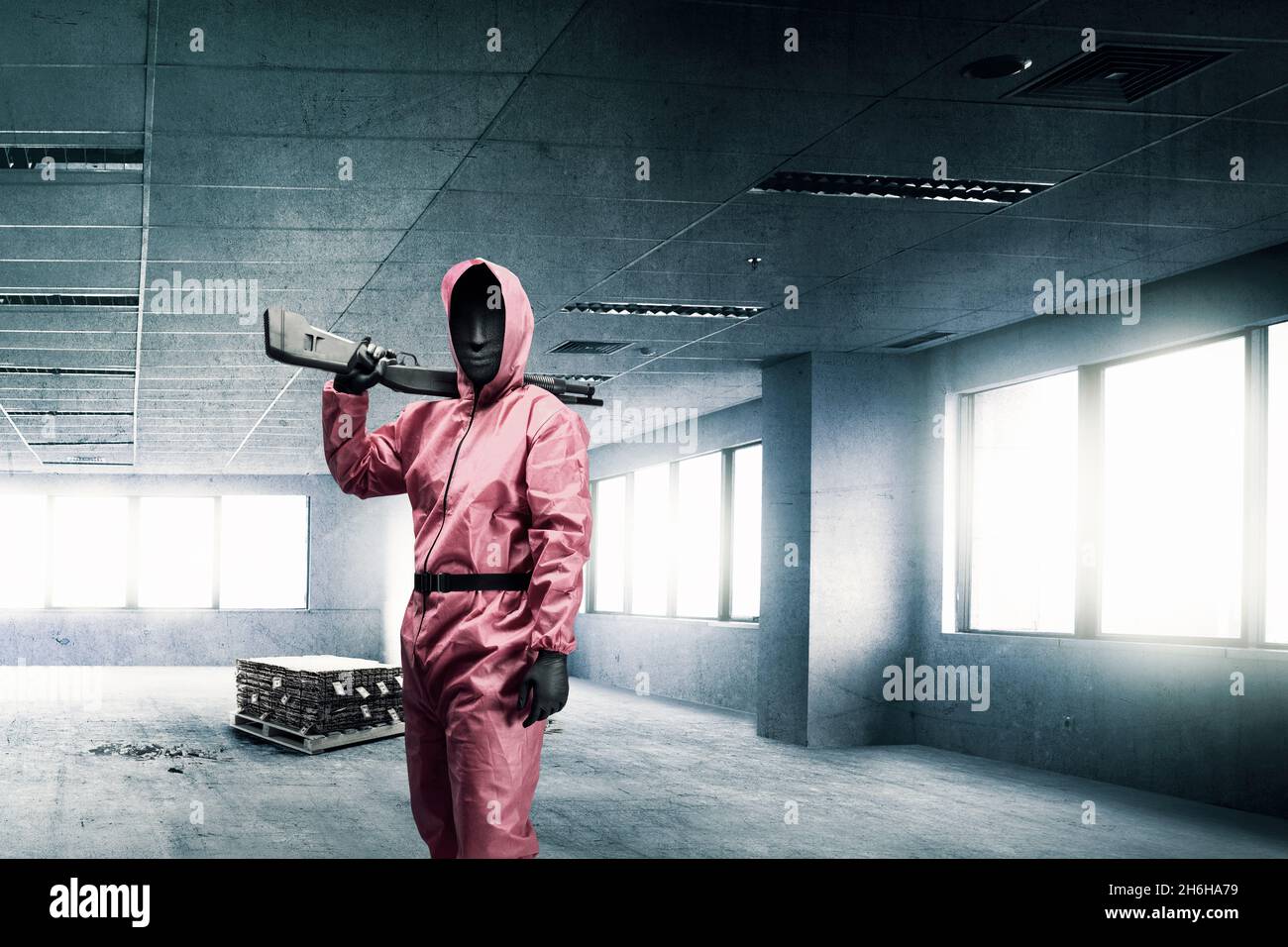 Criminal man in pink uniform and a hidden mask holding the shotgun ...
