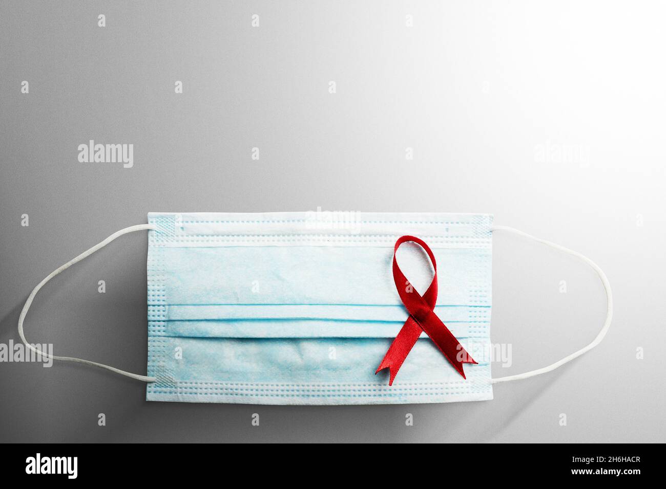 Red ribbon and face mask with white background. Hiv Aids ribbon ...