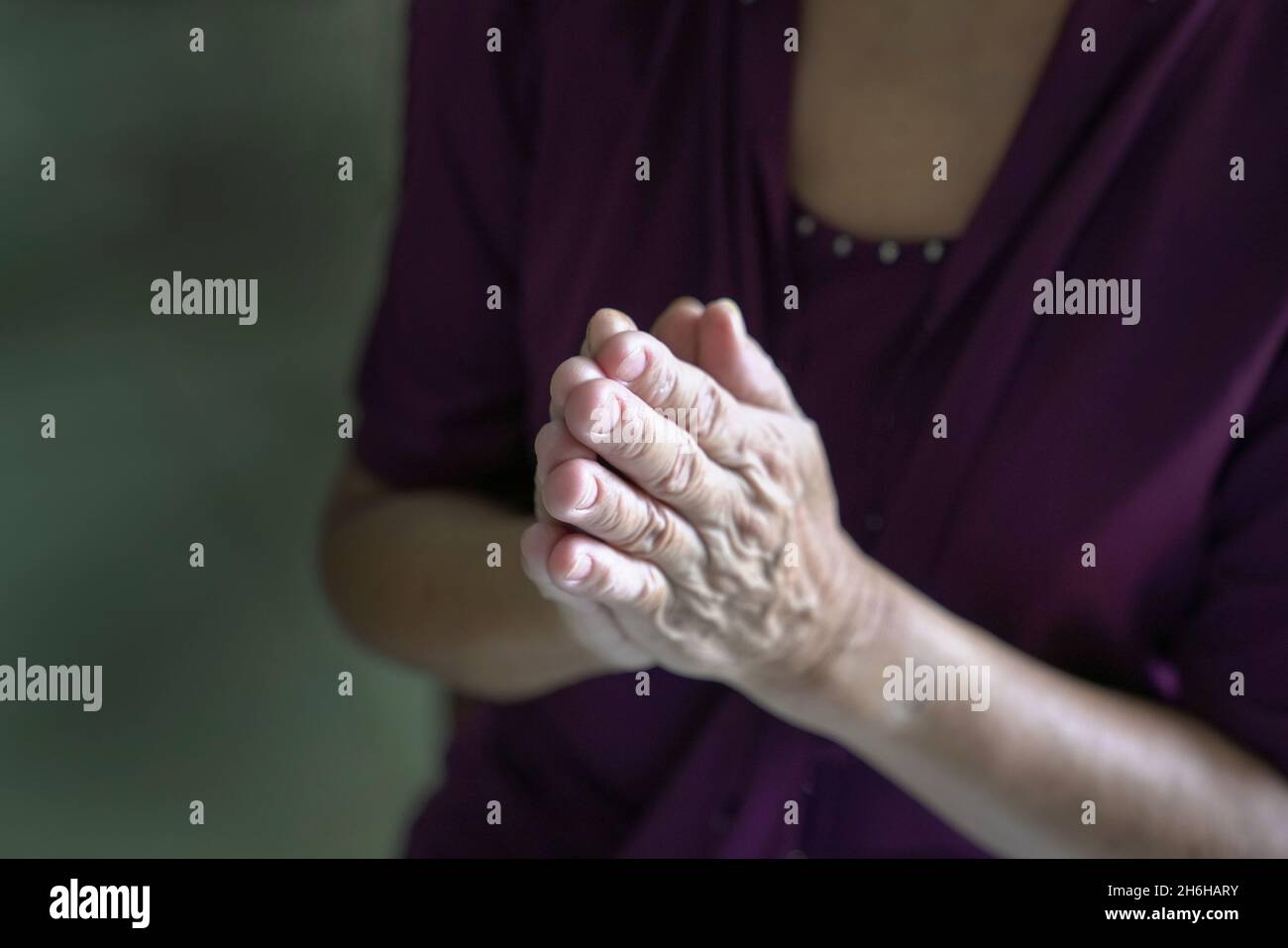 Close up view of hands clasped in prayer. Soft focus Stock Photo - Alamy
