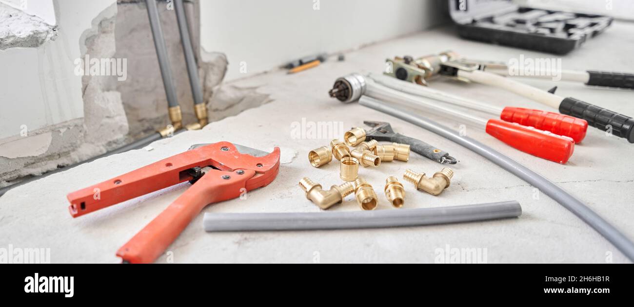 connection heating pipes to white Radiator in a new apartment under ...