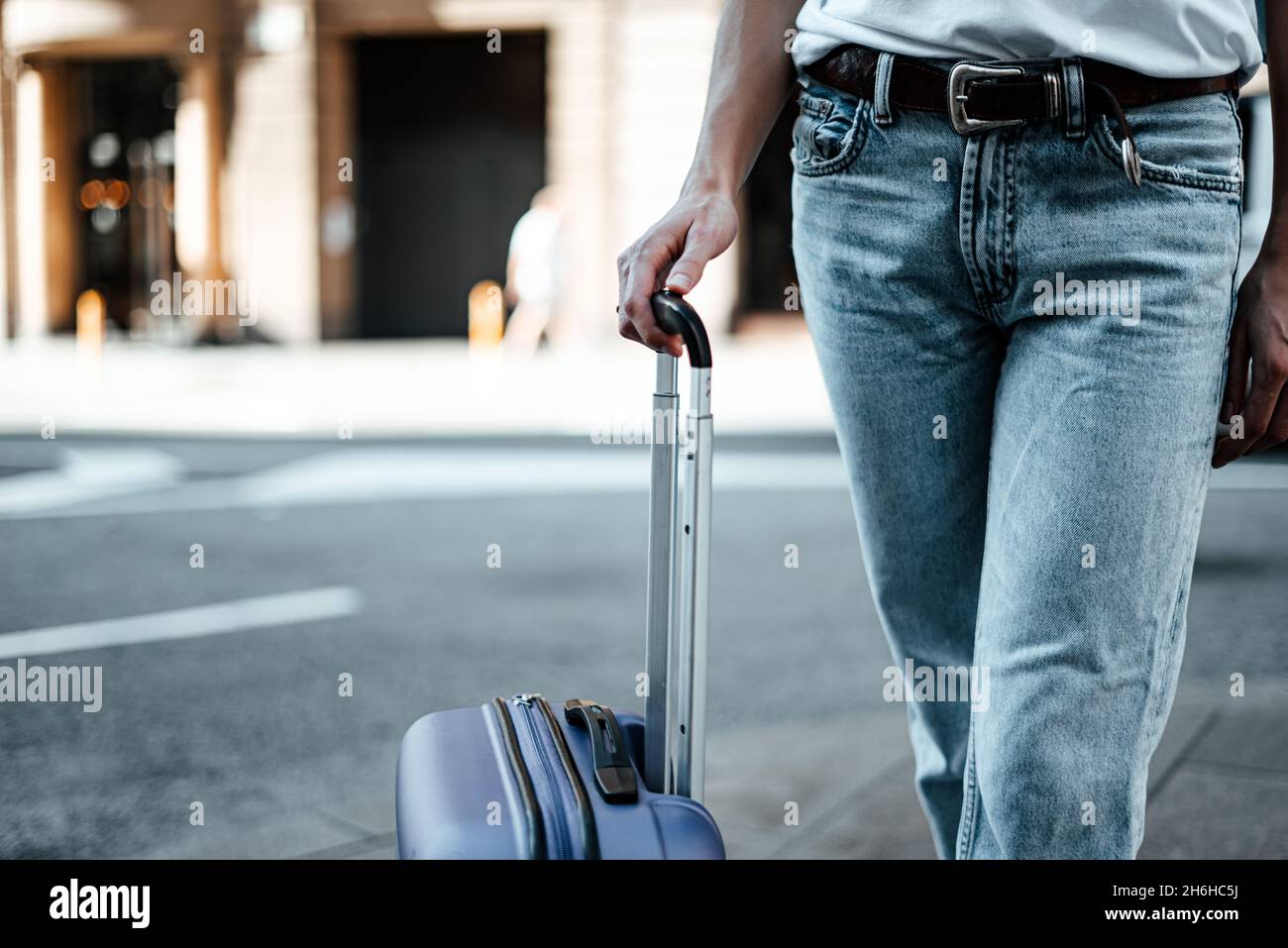 Close-up photo of a female hand holding suitcase. Young traveling woman ...