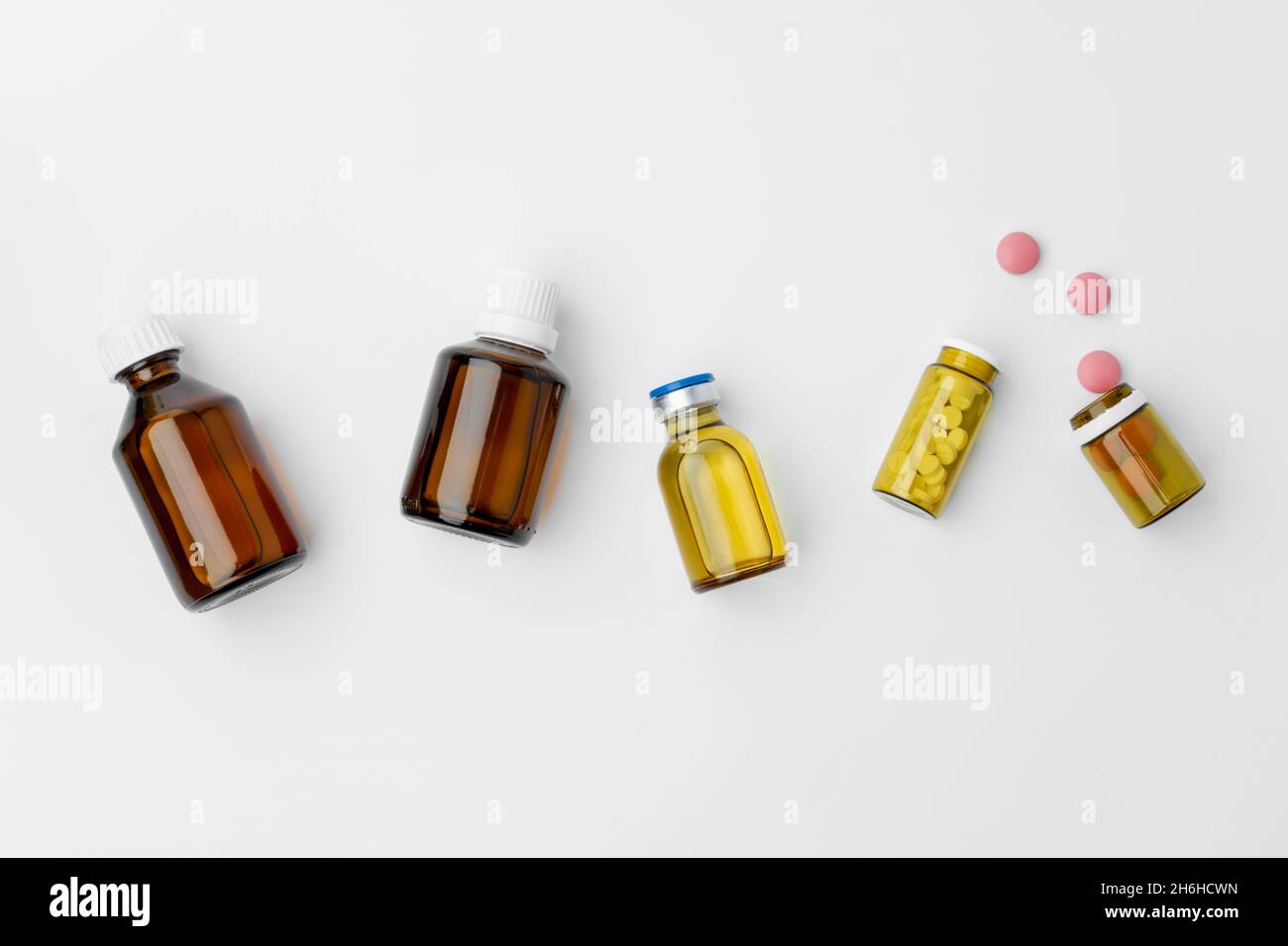 Small glass bottles with medication on white background flat lay Stock ...