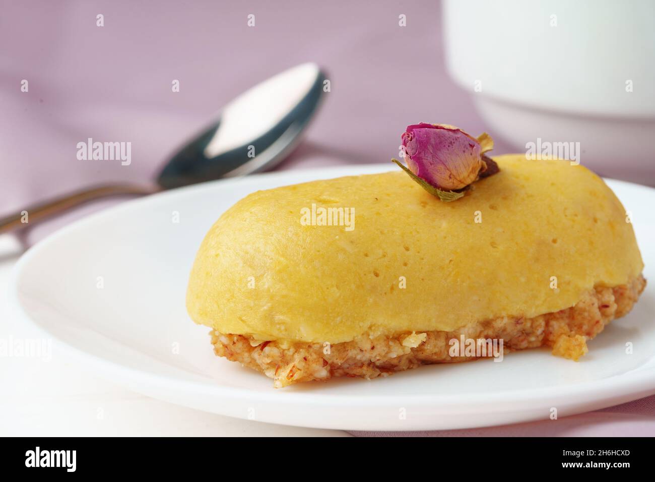 Mini mousse pastry dessert with rose on white plate Stock Photo - Alamy
