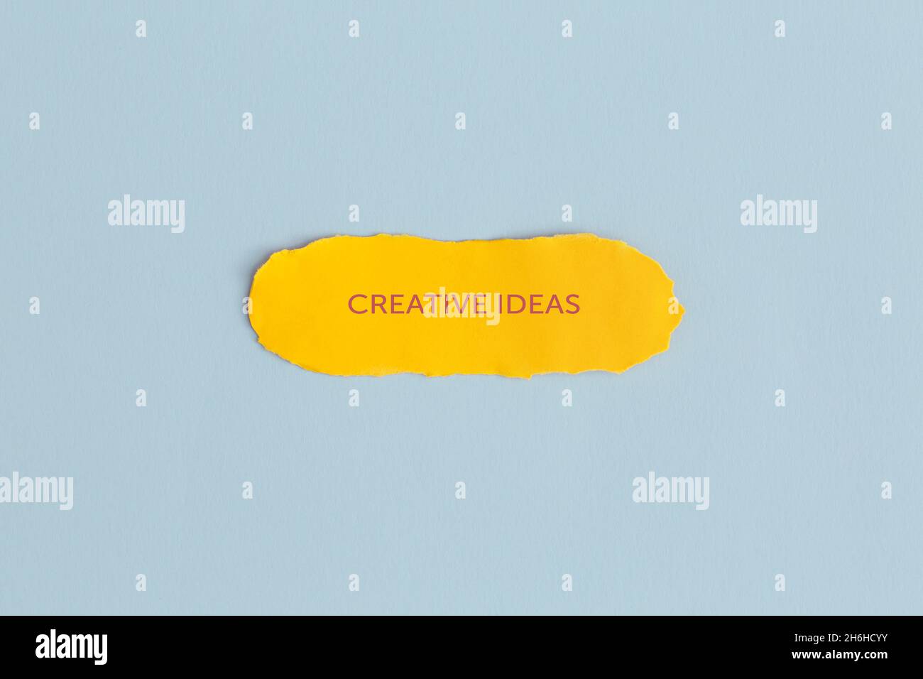 Yellow torn paper with text Creative ideas on blue background Stock ...