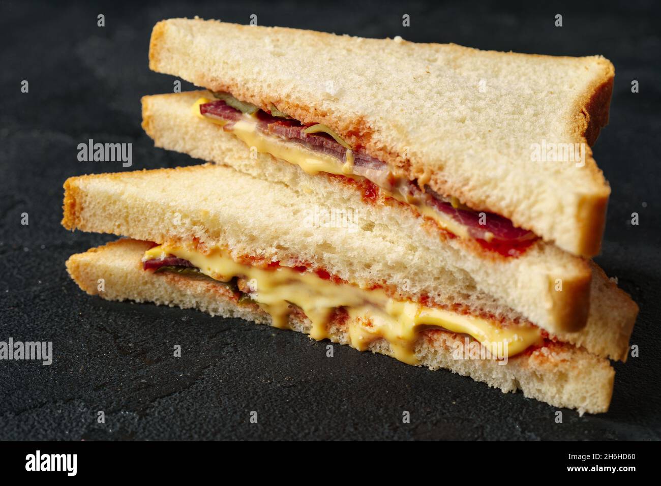 Sandwiches with ham, cheese on dark gray background Stock Photo - Alamy