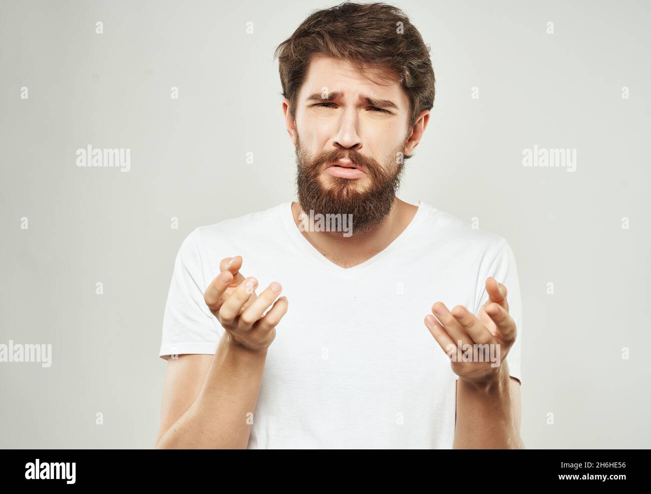 emotional man in a white t-shirt hand gestures anger close-up Stock ...