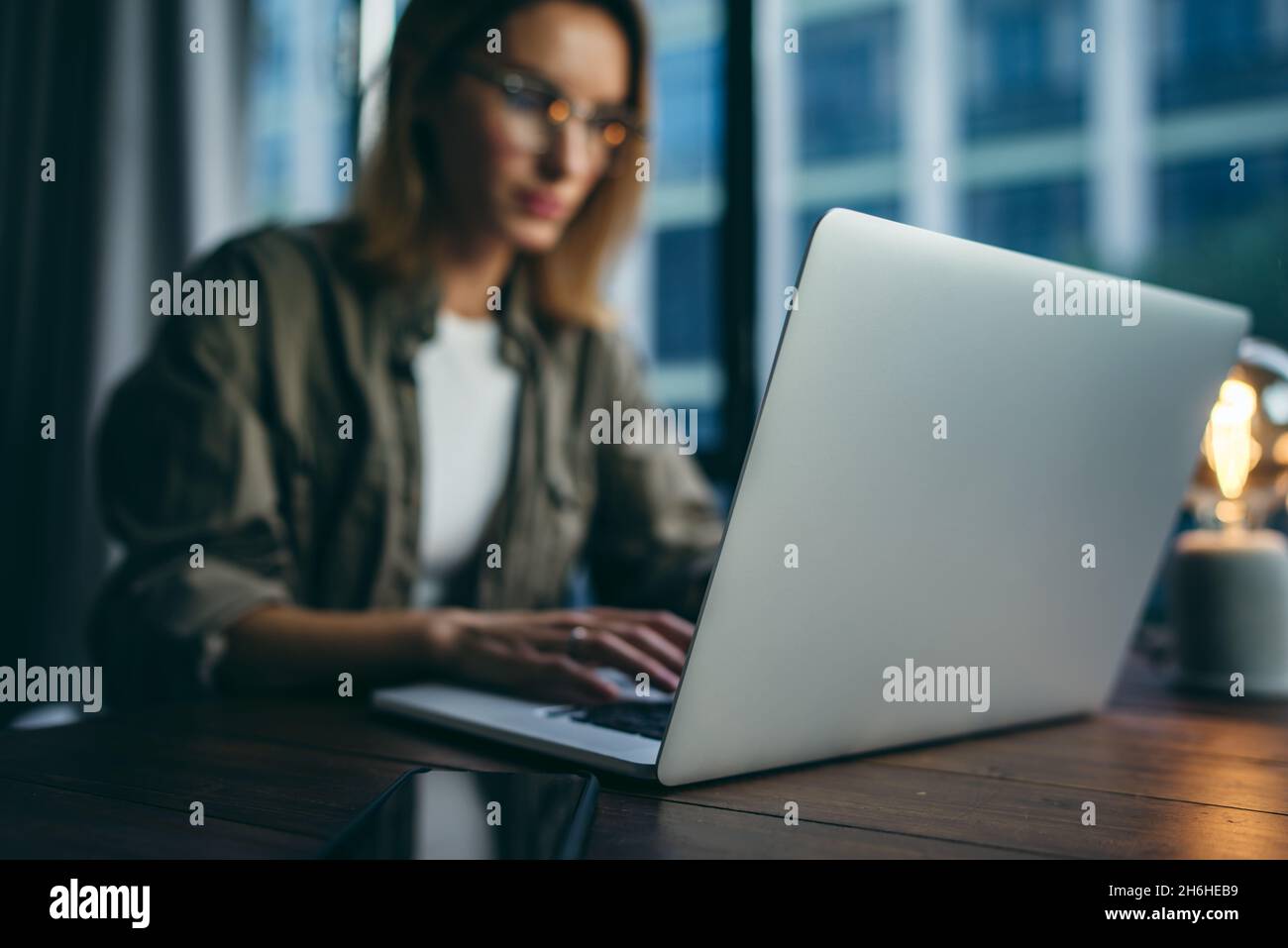 Young woman working with a laptop. Female freelancer connecting to internet via computer ...