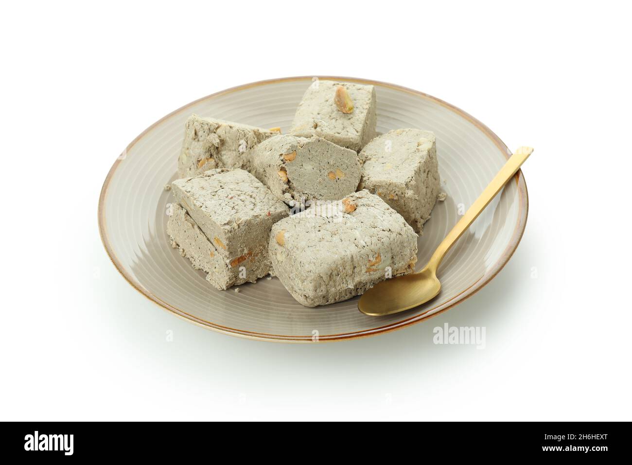 Plate with halva and spoon isolated on white background Stock Photo - Alamy
