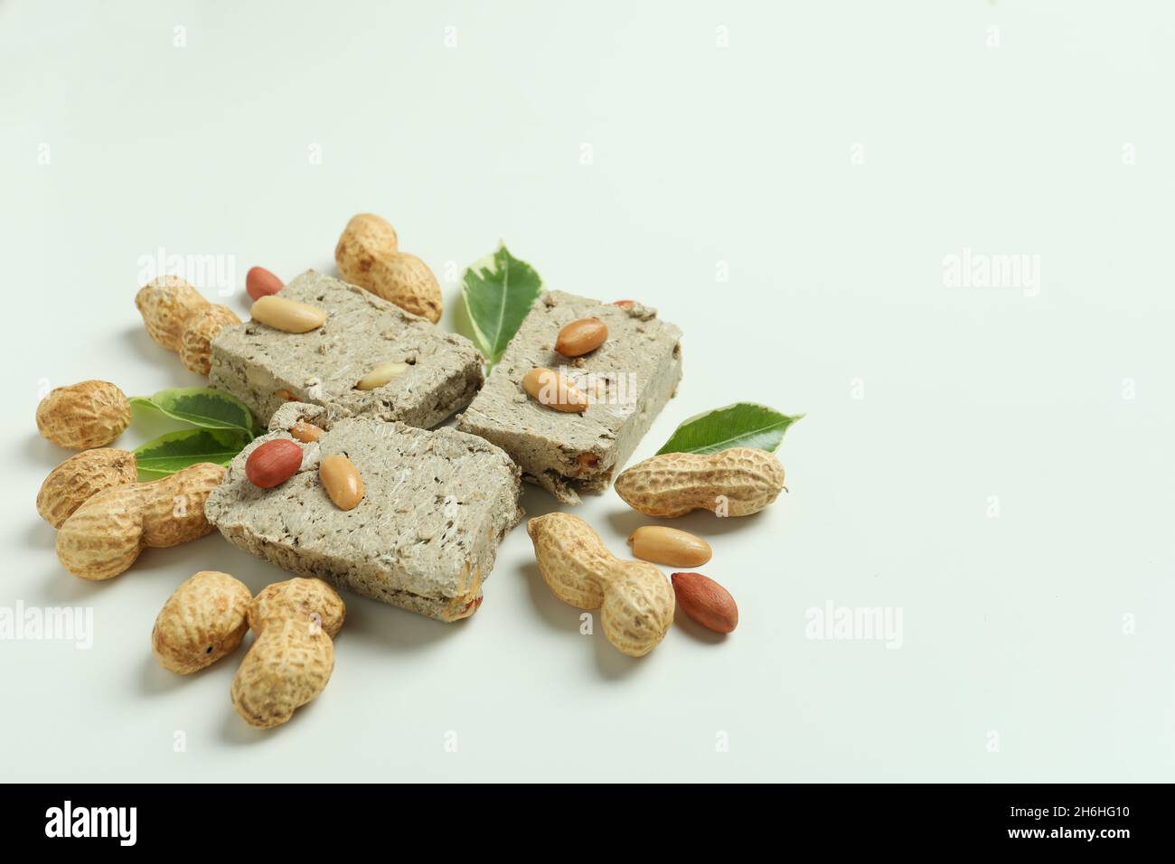 Concept of tasty food with halva and nuts on white background Stock Photo - Alamy