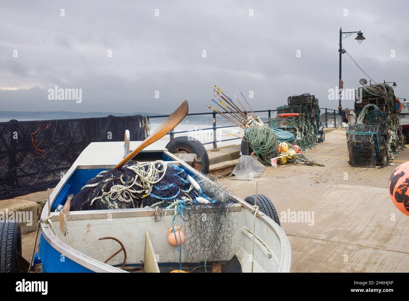 Fishing boats and nets on the beachside at Filey in North Yorkshire ...